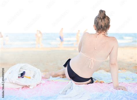 Young Adult Woman With A Fit Body Wears A Bikini With A Thong While