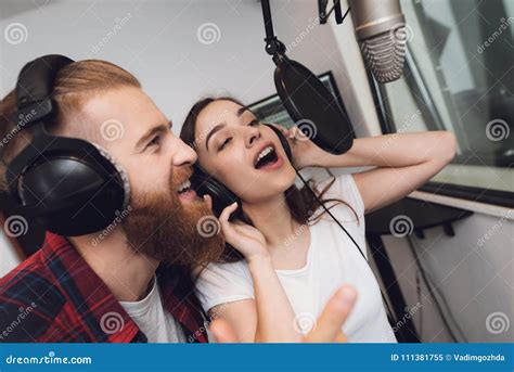 A Man And A Woman Sing A Song In A Modern Recording Studio Stock Image