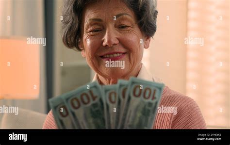 Happy Smiling Rich Caucasian Old Woman Count Money At Home Bills