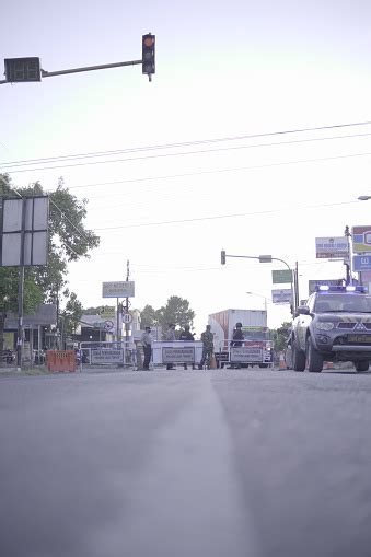 Police Checkpoint With Traffic Signs And Vehicles Blocking The Roadway