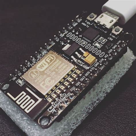 An Electronic Device Sitting On Top Of A Piece Of Plastic With Wires Attached To It