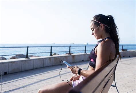 Runner Relaxing On Bench By The Sea By Stocksy Contributor Guille Faingold Stocksy