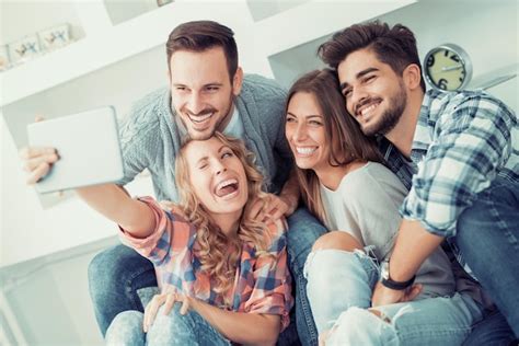 Premium Photo Group Of Four Happy Friends Taking Selfie