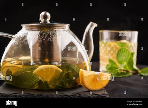 The Process Of Brewing Black Tea With Herbs Glass Teapot With Black
