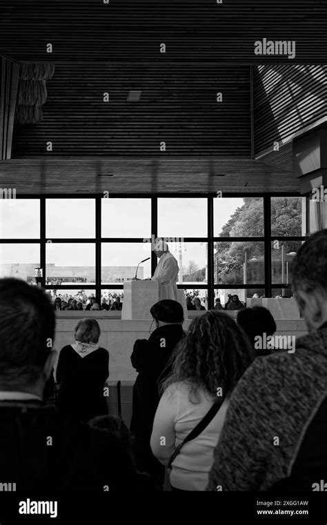 Mature Priest Leads Mass In The Chapel Of Apparitions Viewed From A