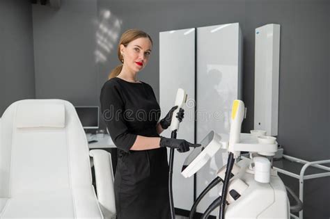 Doctor Cosmetologist Adjusts The Device For Photorejuvenation Using The
