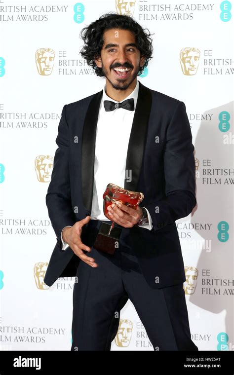 Dev Patel Winner Of The Best Supporting Actor Award Poses In The