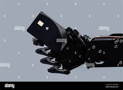 Real Robotic Hand With Black Contactless Payment Card Concept Of Artificial Intelligence In