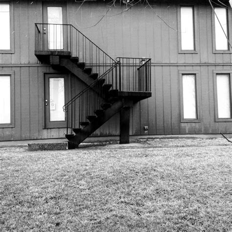 Premium Photo Grassy Field Against Staircase On Building