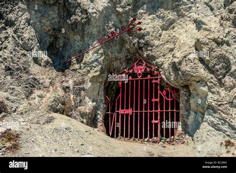 Red Diabolic Steel Gate In The Wall Of Rocks Entrance To Hell Tourist