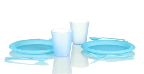 Premium Photo Bright Plastic Disposable Tableware Isolated On White