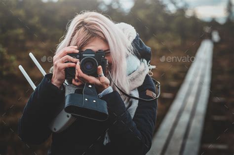 Girl Is Taking A Photo Using Her Photo Camera Stock Photo By Fxquadro