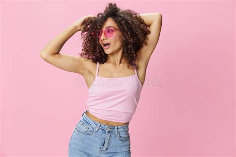 Happy Woman Afro Curls Hair Dancing On A Pink Background In Summer Pink T Shirt Jeans And