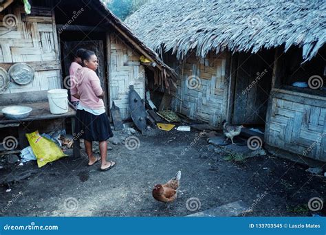 Local Village Girls Waiting Next To Their Traditional Bamboo Woven Palm