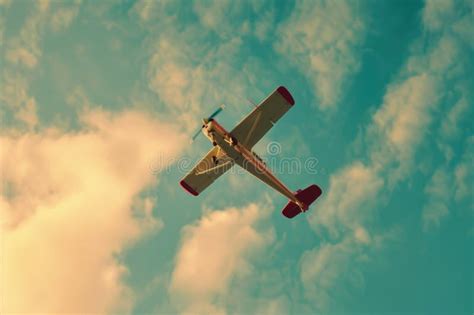 A Small Plane Flying Through A Cloudy Blue Sky Suitable For Aviation