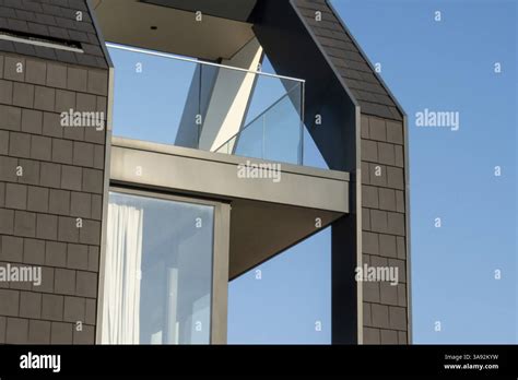 Modern Architectural Detail Featuring A Glass Balcony Dark Tile