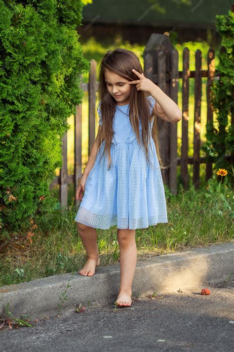 Premium Photo Little Beautiful Girl In A Blue Dress Barefoot In The