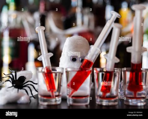 Creepy Halloween Party Cocktails With Syringes Of Grenadine Syrup As