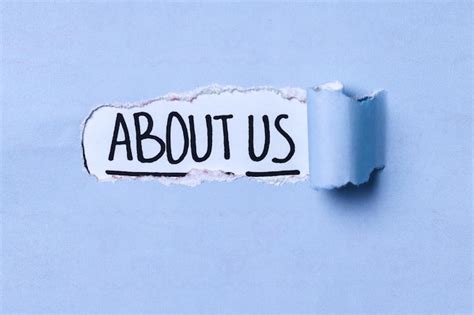 Premium Photo Text About Us Appearing Behind Torn Blue Paper About Us