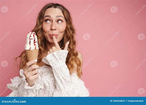 Young Ginger Woman Licking Her Finger While Eating Ice Cream Stock