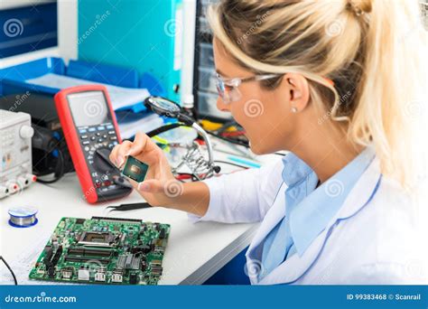 Female Electronic Engineer Checking Cpu Microchip In Laboratory Stock