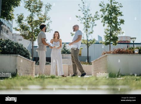 A Team Of Architects And Engineers Discuss And Plan A Modern Building Collaborating On