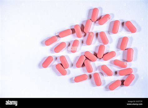 Top View Of Scattered Red Tabletscapsules Spilled On White Surface