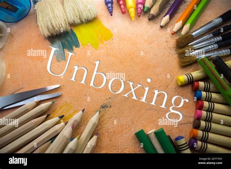 overhead shot of school supplies with unboxing text brushes pencils
