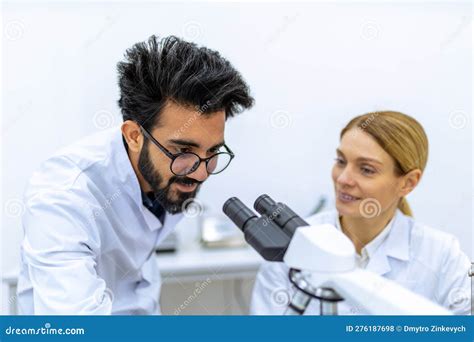 Scientists Using Microscope Doing Sample Analysis Talking Team Of