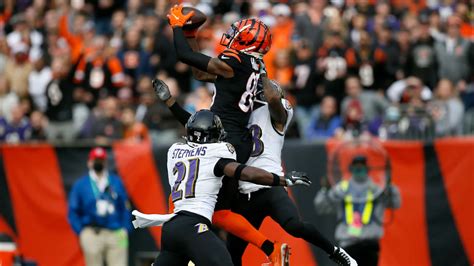 Download Tee Higgins Catching Football Against Ravens Defense Wallpaper