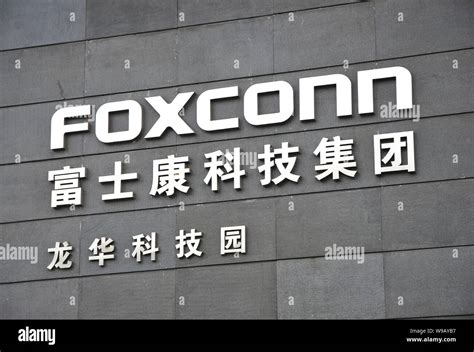 The Logo Of Foxconn Technology Group Is Seen At One Entrance Of The