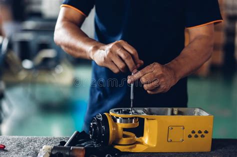 Engineer Or Technician Assemble Parts Of New Robot Arms In The Factory