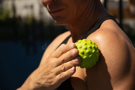 Athletes Man Is Massaging His Shoulder By Massage Ball Techniques For
