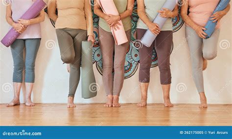 Yoga Fitness Class And Pilates With Women At Wall With Exercise Mat