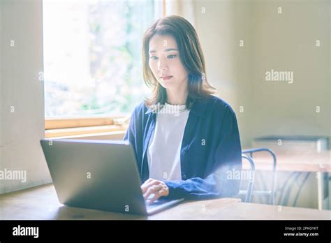 Woman Operating Laptop Near Window Stock Photo Alamy