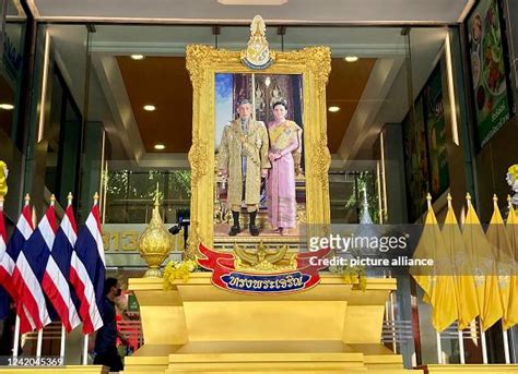 In Front Of A Public Building On Silom Road Stands A Large Photo In A