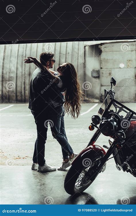 Junge Paare In Der Umarmenden Liebe Bei Der Stellung In Der Garage Mit