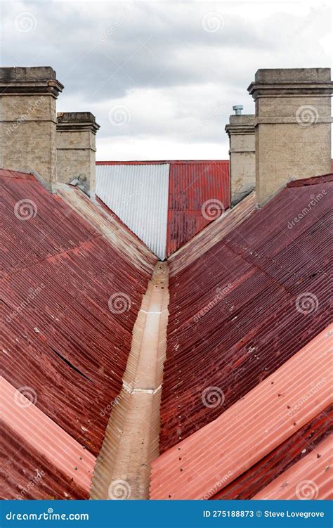 Gable Roof Of New And Old Rusty Sheets Of Corrugated Iron Royalty Free