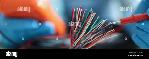 Man Measuring Voltage With Special Equipment Tool For Checking Pressure Bunch Of Wires Stock