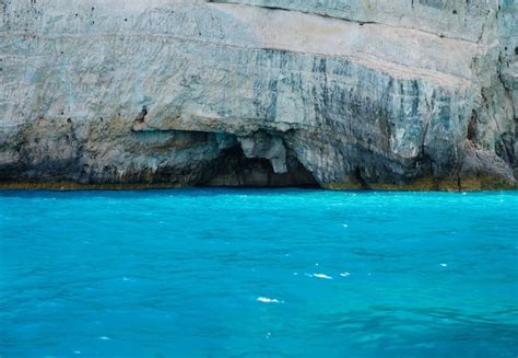 Premium Photo Rocks And Azure Water A Cave In The Rock Natural