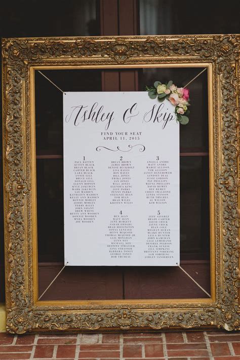 Seating Chart In Ornate Antique Frame With Fresh Flower Accent