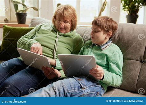 Mom Dad Granny And Grandson Together In Kitchen Preparing Food Stock
