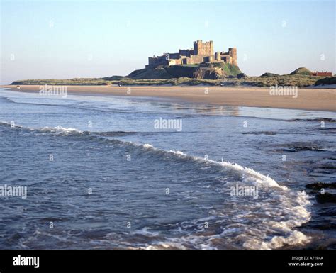 Bamburgh Castle Beyond Sand Beach And Dunes Northumberland England Uk
