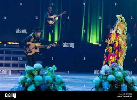 A Team Of Musicians And Singers Perform On Stage In Front Of The