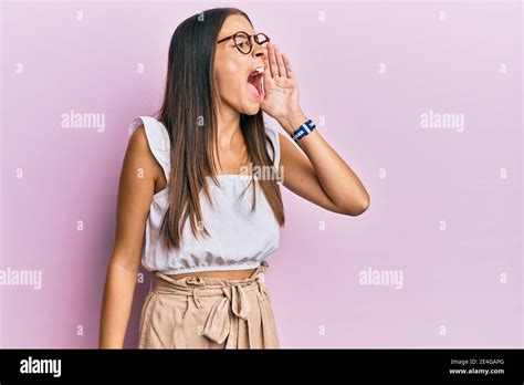 Young Hispanic Woman Wearing Casual Clothes And Glasses Shouting And