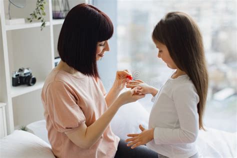 Young Mom Teaches Her Daughter To Take Care Of Herself Stock Image