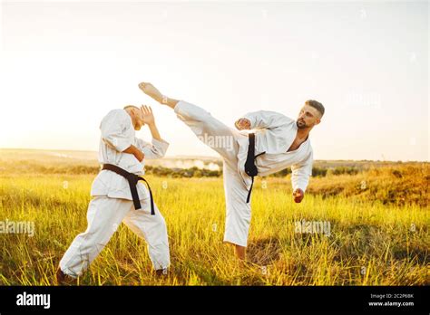 Two Karate Fighters Kick In The Stomach In Action Training Fight In