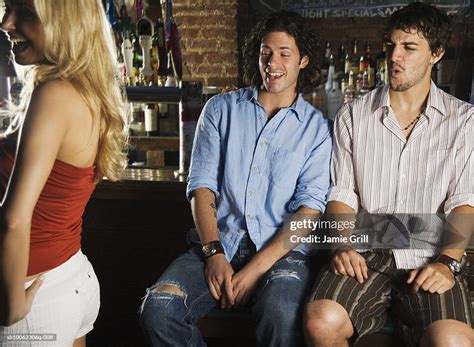 Two Young Men Flirting Woman In Bar Foto De Stock Getty Images
