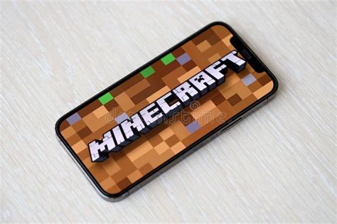 Minecraft Mobile Ios Game On Iphone 15 Smartphone Screen On Wooden
