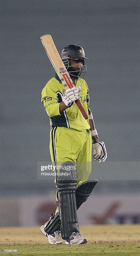 Pakistan Cricketer Mohammad Yousuf Raises His Bat After Completing A